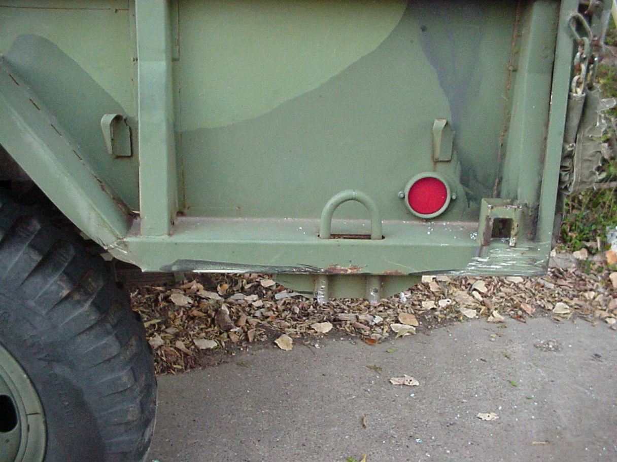 small car meets M105 trailer